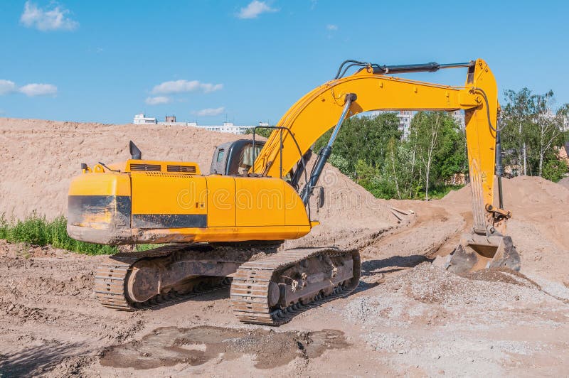 Excavator digs a hole. stock photo. Image of engineering - 181809426
