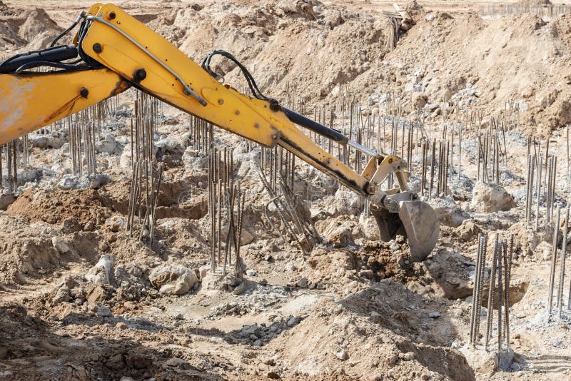 Excavator Digs Piles. Earthworks for the Construction of the Foundation ...