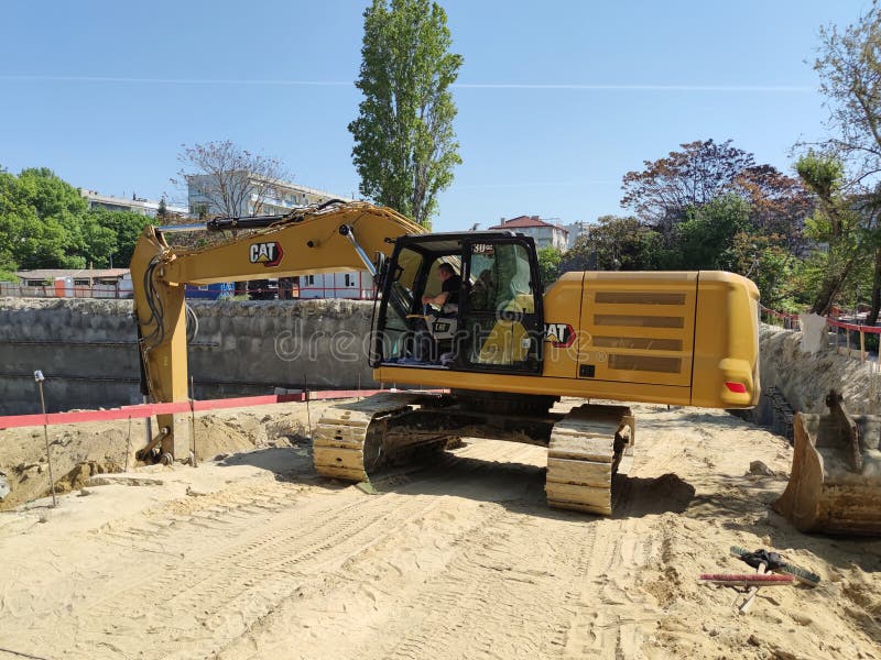 An Excavator Digs a Pit for the Foundation of a Large Building ...