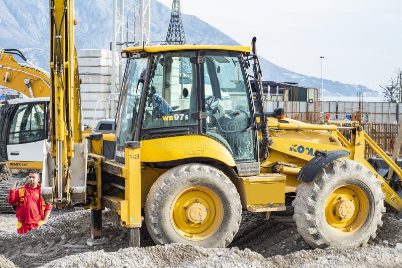 Excavator Digs a Pit, a Worker is Directing the Work Editorial Stock ...