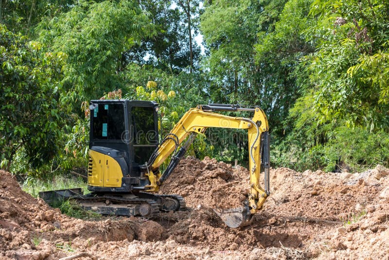 The Excavator Digs a Soil. Digger Loading Trucks with Soil. Excavator ...