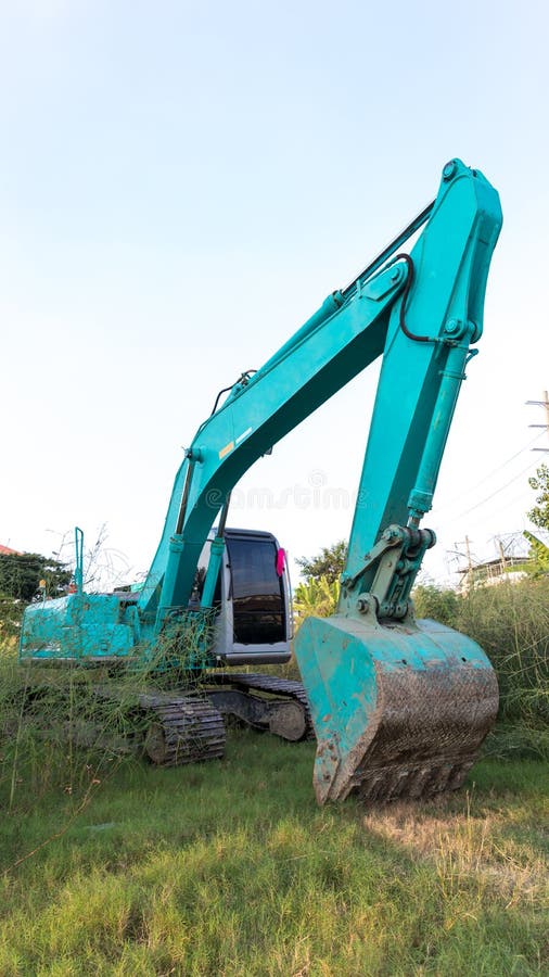 The Excavator Digs a Soil. Digger Loading Trucks with Soil. Excavator ...