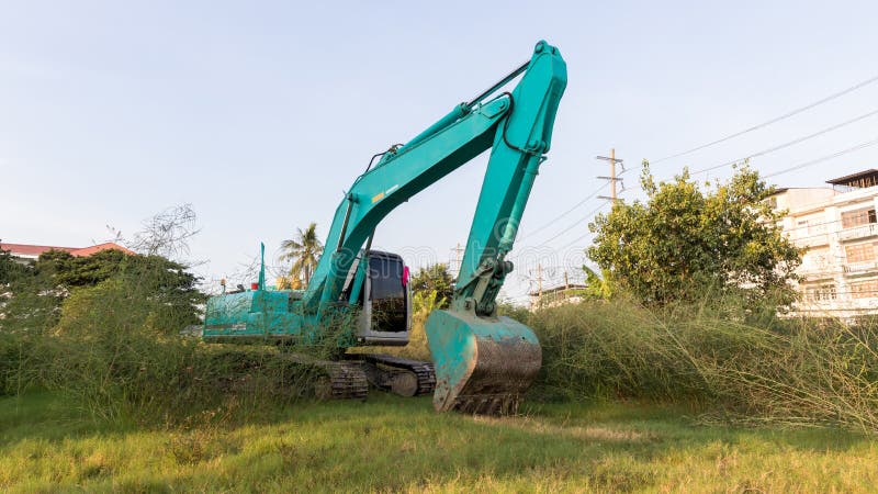 The Excavator Digs a Soil. Digger Loading Trucks with Soil. Excavator ...