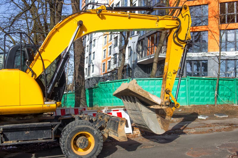 Excavator Doing Construction Work on a Section of Road Stock Image ...