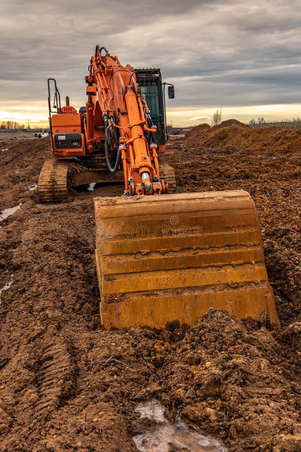 Excavator Doing Work on a Wet and Muddy Winter Day Stock Photo - Image ...