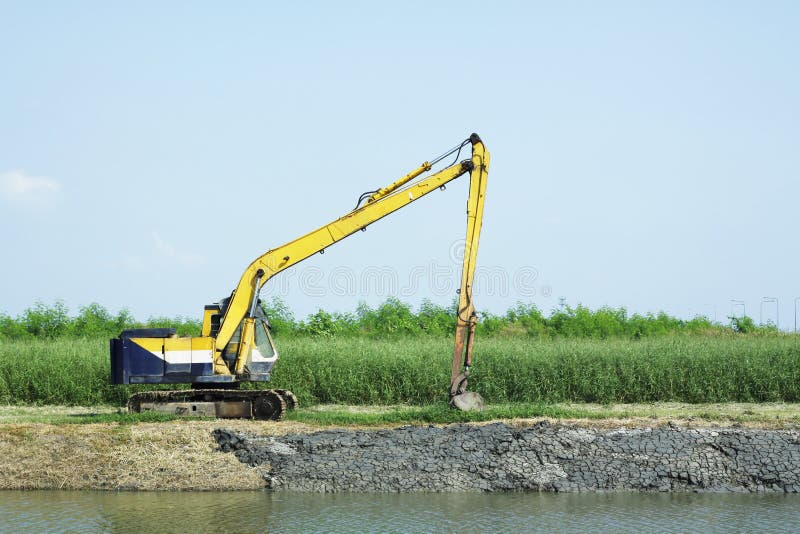 Excavator Dredging the Canal Stock Photo - Image of water, excavator ...