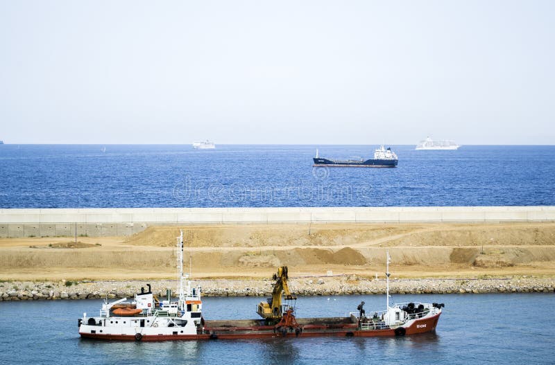 Excavator dredging on ship editorial stock image. Image of barge ...