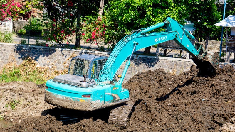 Excavator Driver is Digging Soil in the River To Make the Water Flow ...