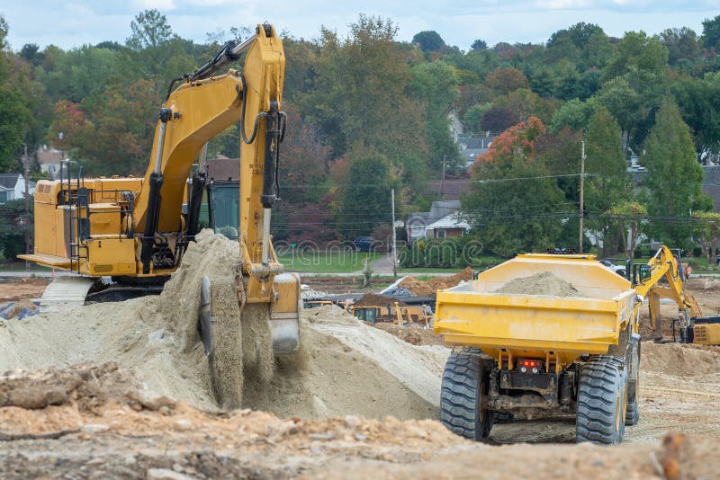Excavator and Dump Truck at Construction Site Stock Image - Image of ...