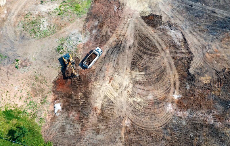 Excavator and Dump Trucks Working at the Construction Site Stock Photo ...