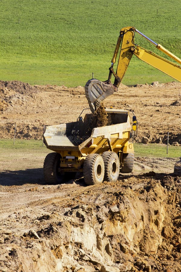 Excavator Dumping Soil and Sand Onto Truck Stock Photo - Image of ...