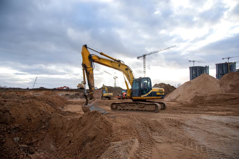 Excavator during Earthmoving at Construction Site. Backhoe Dig Ground ...