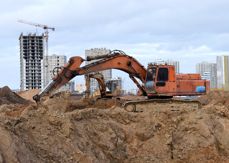 Excavator during Earthmoving Work at Construction Site. Backhoe Digging ...