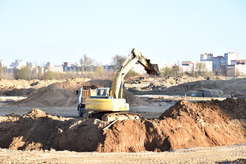 Excavator during Earthmoving Work at Construction Site. Backhoe Digging ...