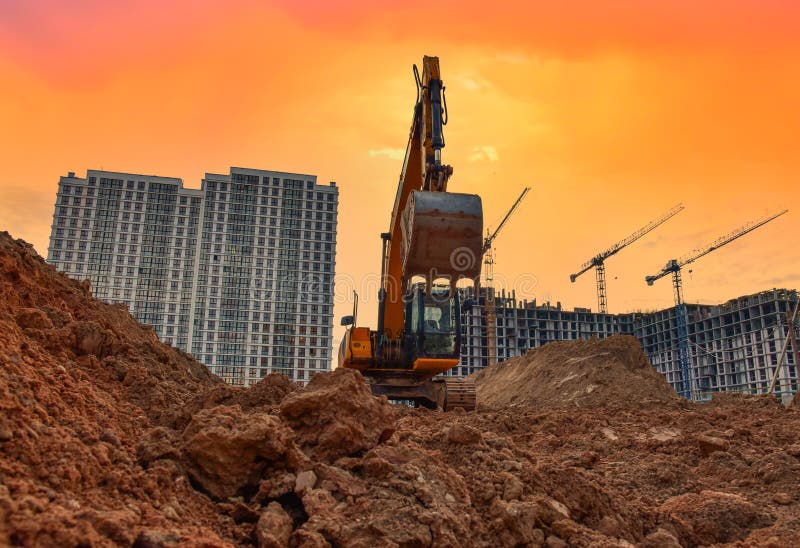 Excavator during Earthmoving Work at Construction Site on Sunset ...