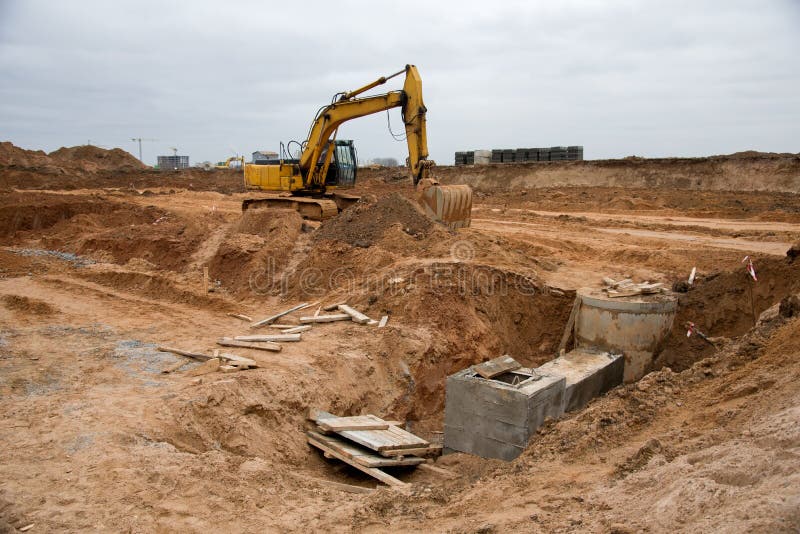 Excavator at Earthworks on Construction Site. Backhoe Loader Digs a Pit ...