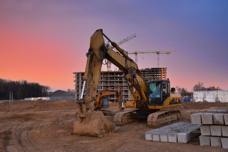 Excavator on Earthworks at Construction Site on Sunset Backround ...