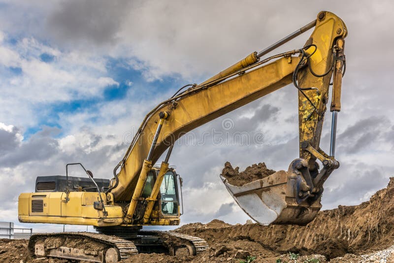 An Excavator Extracting Dirt in a Construction Site Stock Image - Image ...
