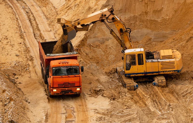 Excavator Extracts and Loads Sand into Large Truck in Sand Quarry Stock ...