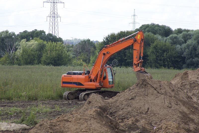 Excavator in the field stock image. Image of earthwork - 66041201
