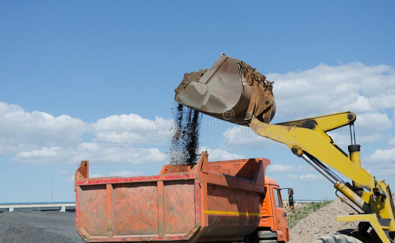 Excavator on Gravel Pile Loading a Truck Stock Photo - Image of gravel ...