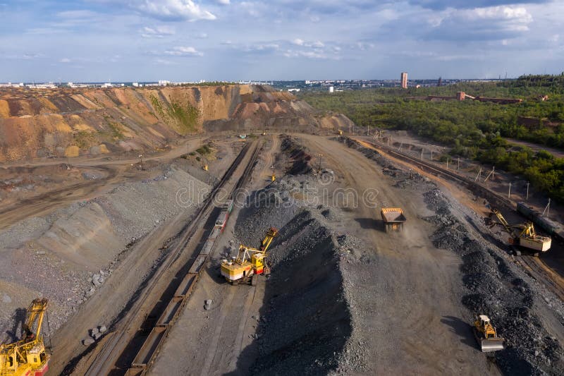 Excavator and Heavy Mining Dump Trucks in a Limestone Quarry, Loading ...