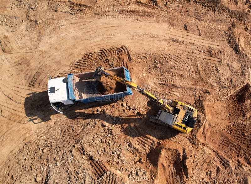 Excavator Load the Sand into Dump Truck. Aerial View of an Backhoe on ...