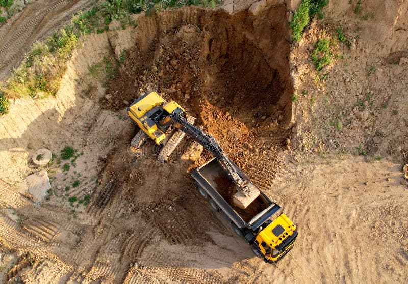 Excavator Load the Sand into Dump Truck. Aerial View of an Backhoe on ...