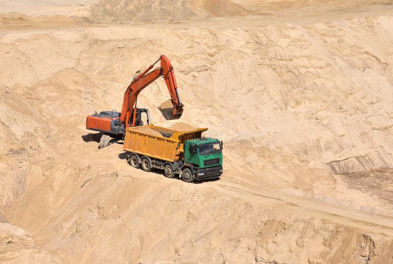 Excavator Load the Sand into Dump Truck in Open-pit Mining. Developing ...