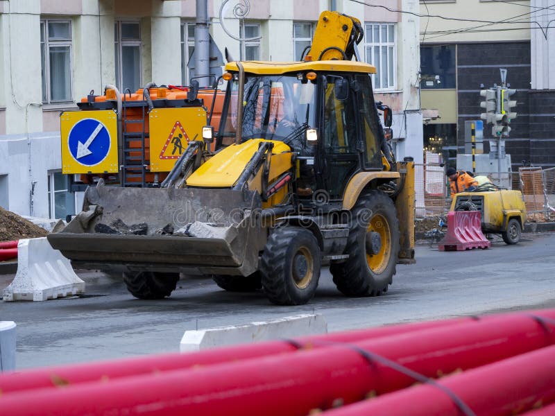 Excavator - Loader Rides on the Construction Site. in the Foreground ...