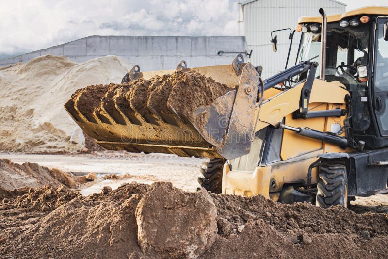 The Excavator Loader Works with a Bucket for Transporting Sand at a ...
