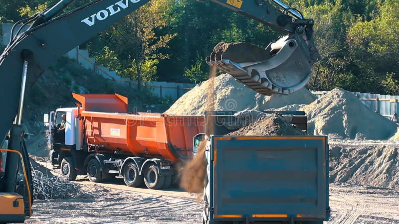 The Excavator Loading Crushed Stone into a Dump Truck in a Crushed ...