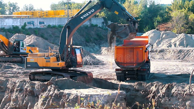The Excavator Loading Crushed Stone into a Dump Truck in a Crushed ...