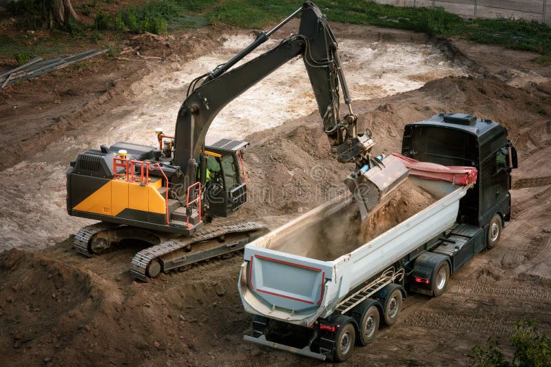 Excavator Loading Dirt into a Truck, View from Above Stock Image ...