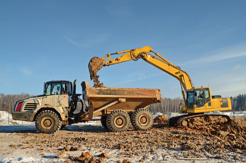 Excavator loading dumper stock image. Image of earth - 37054329