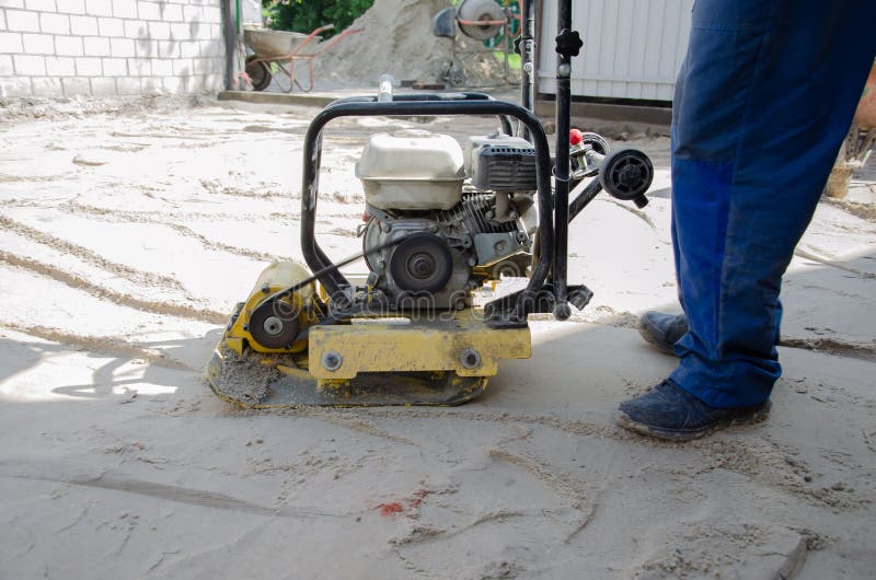 An Excavator is Loading Earth into a Dump Truck, Which is Heavy ...