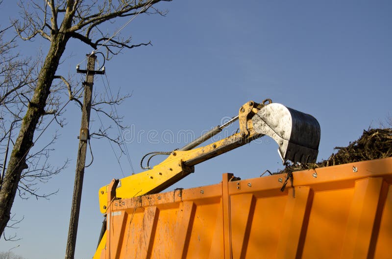 Excavator Loading Soil into Dumper Truck Stock Photo - Image of ...