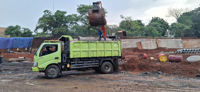 Excavator Loading Soil Onto a Dump Truck at a Construction Site ...