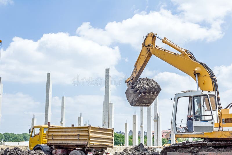 Excavator is Loading a Truck on Building Site Stock Photo - Image of ...