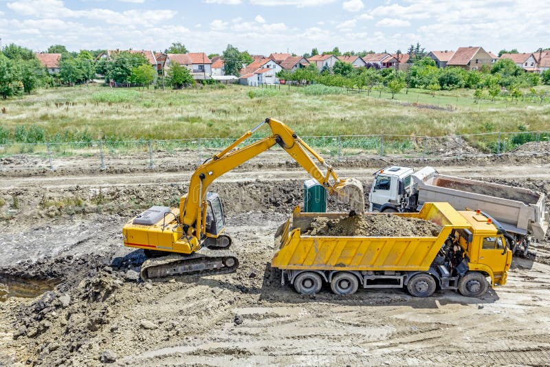 Excavator is Loading a Truck on Building Site Stock Photo - Image of ...