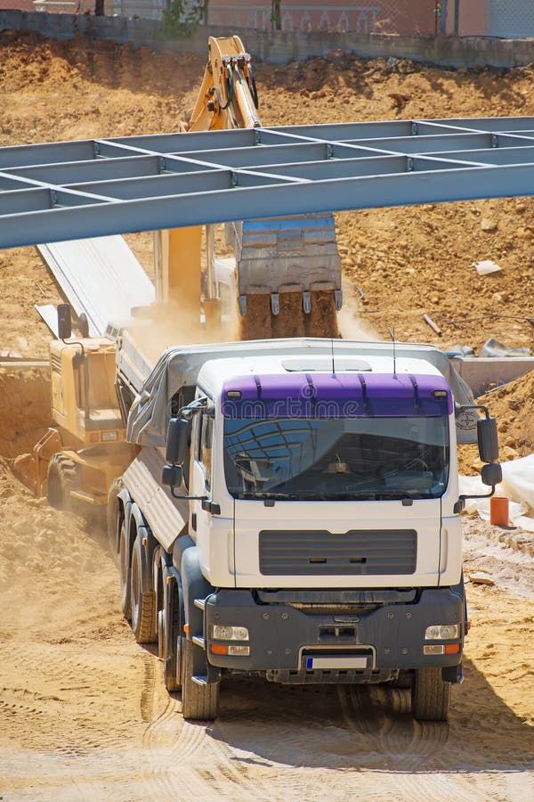 Excavator loading truck. stock image. Image of digger - 61057015