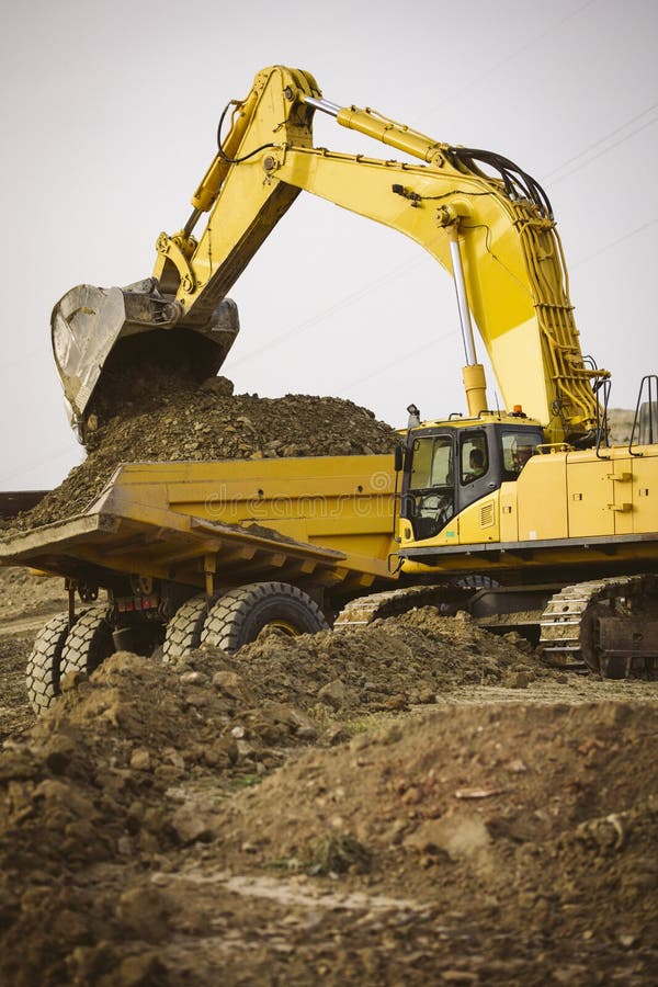 Excavator loading a truck. stock image. Image of moving - 115998491