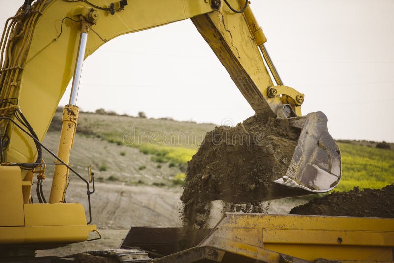 Excavator loading a truck. stock photo. Image of moving - 115998312