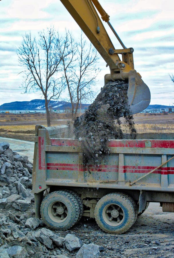 Excavator loading a truck. editorial stock image. Image of site - 115998214