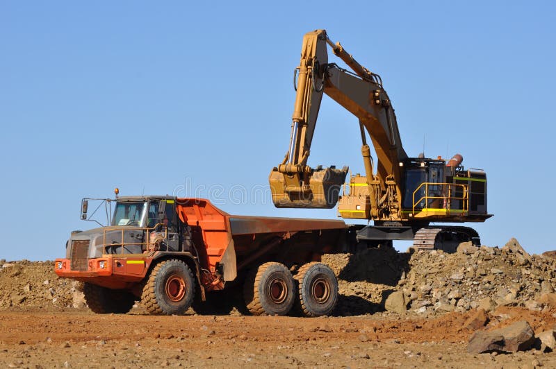 Mining Excavator Loading Truck in Mine Quarry Stock Photo - Image of ...