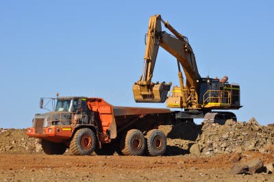 Mining Excavator Loading Truck in Mine Quarry Stock Photo - Image of ...