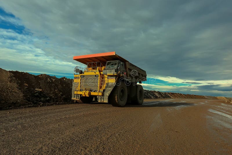 The Excavator is Loading a Yellow Mining Truck. Open Pit Mining ...