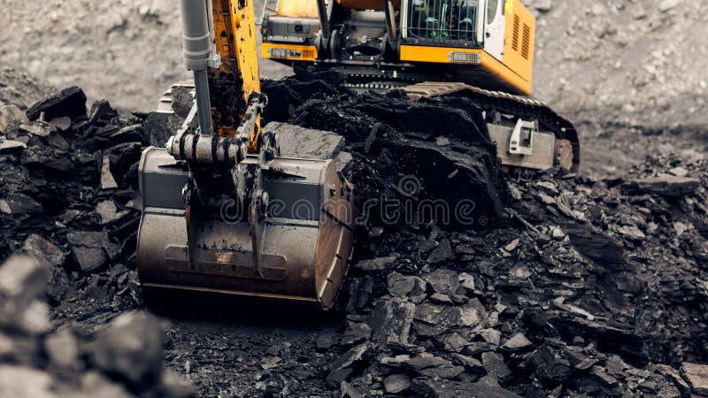 Excavator Loads Coal into the Back of a Heavy Mining Dump Truck. Stock ...