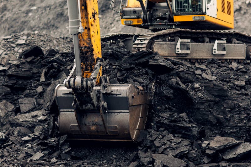 Excavator Loads Coal into the Back of a Heavy Mining Dump Truck. Stock ...