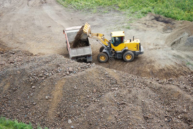 Excavator Loads Crushed Stone into Dump Truck Stock Photo - Image of ...